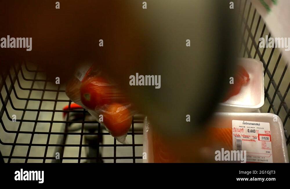 Customer buying food and staples from a cashier in trolley. Video shift ...