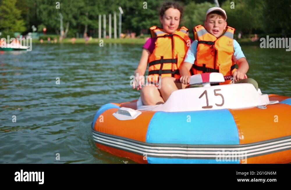 Son and mother in life jackets floating down the river Stock Video ...