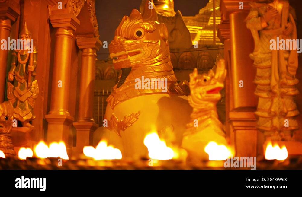 statues of mythical monsters in a buddhist temple at night. ritual ...