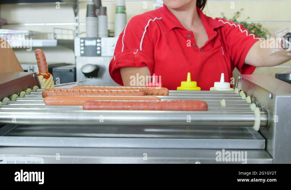 Woman employee prepares hot dogs in a fast food restaurant Stock Video ...