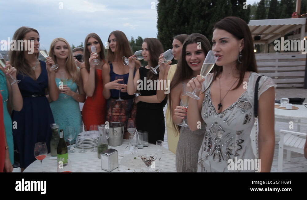 Gorgeous girls at a banquet in an expensive restaurant on the terrace ...