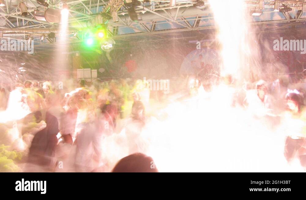 Young people dancing on a foam party in illuminated nightclub Stock ...