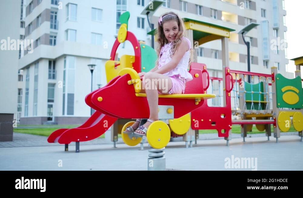 Little girl rides on plane swing at children playground Stock Video ...