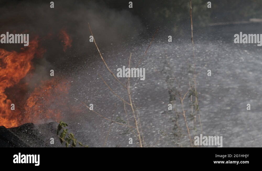 Brave firefighter extinguishes a strong fire Stock Video Footage - Alamy