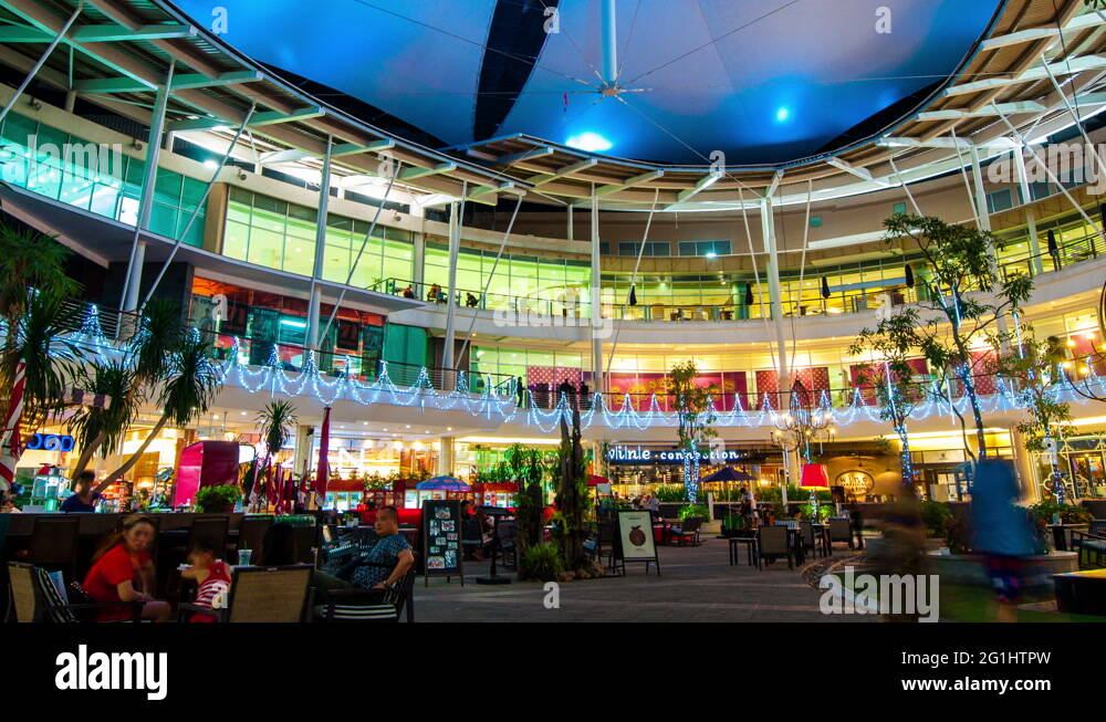 4K TimeLapse - People walk on a night mall with fountains and light ...