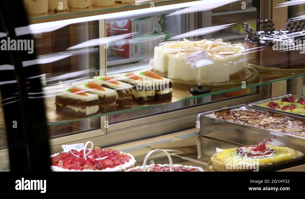 Showcase of cakes, pastry in window display canteen for sale tasty ...