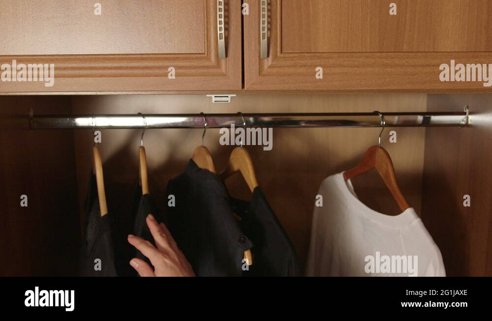 Woman opens doors of half empty wardrobe Stock Video Footage - Alamy