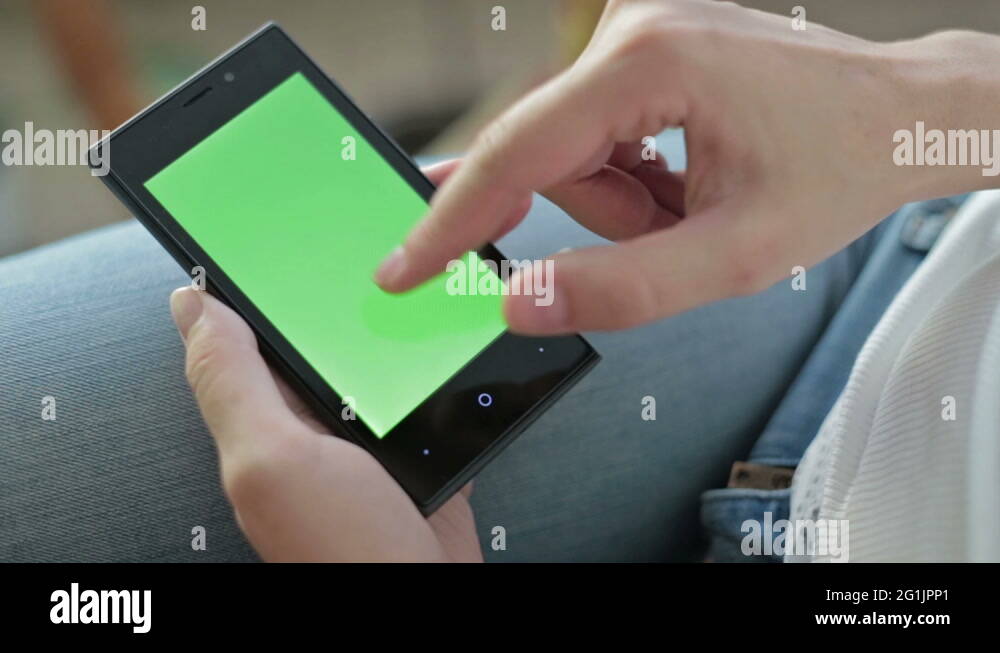 Woman hands touching and scrolling smartphone.green screen display ...