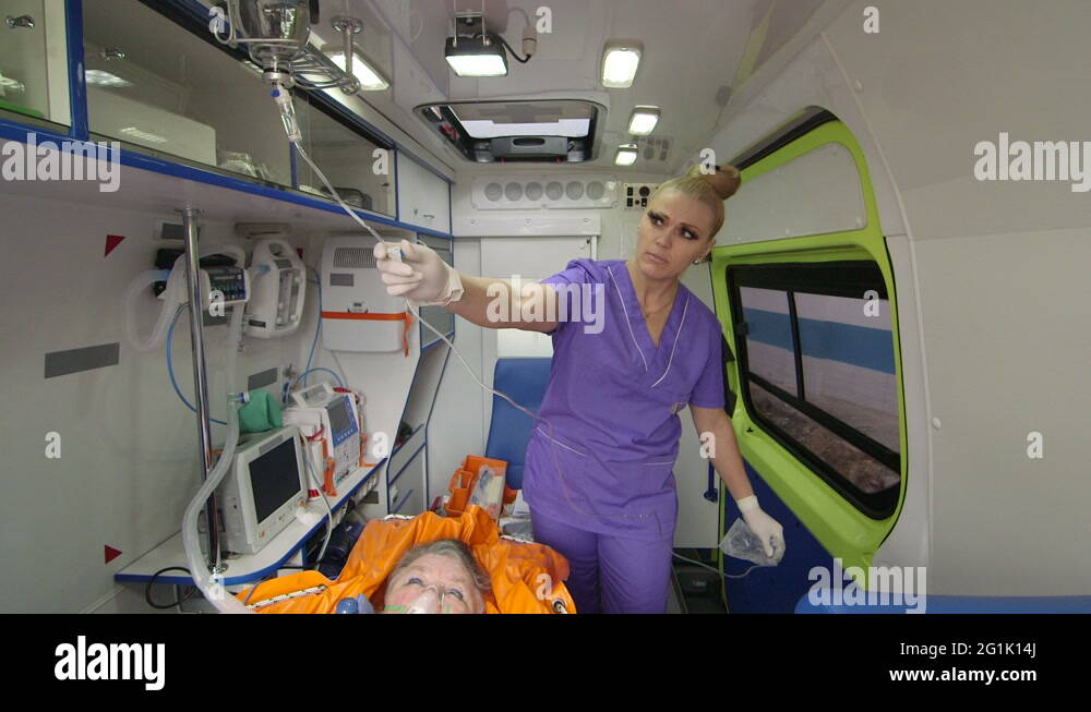 EMT provide emergency medical care to patient in ambulance intravenous ...