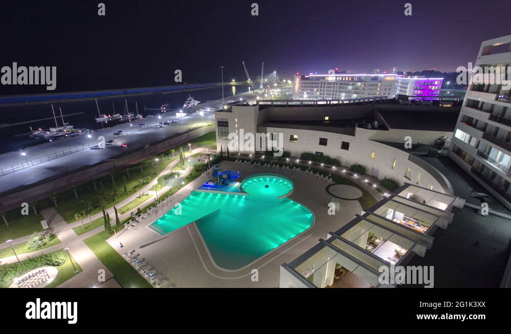 Sea beach, swimming pool and yacht in the sea at night timelapse. Top ...