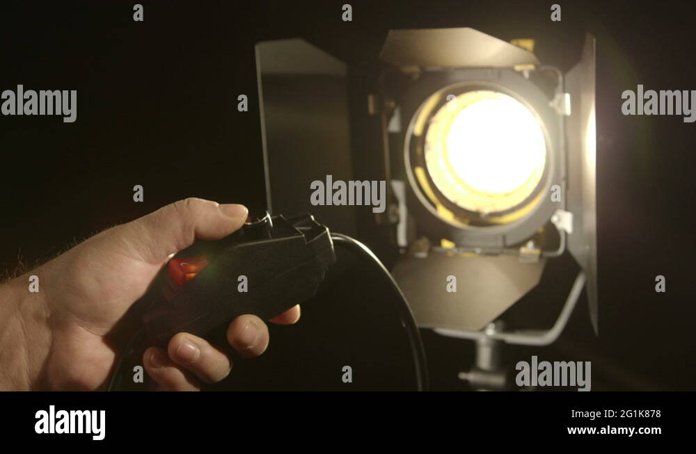 Dimming video studio Fresnel lens spot light on black background turn ...