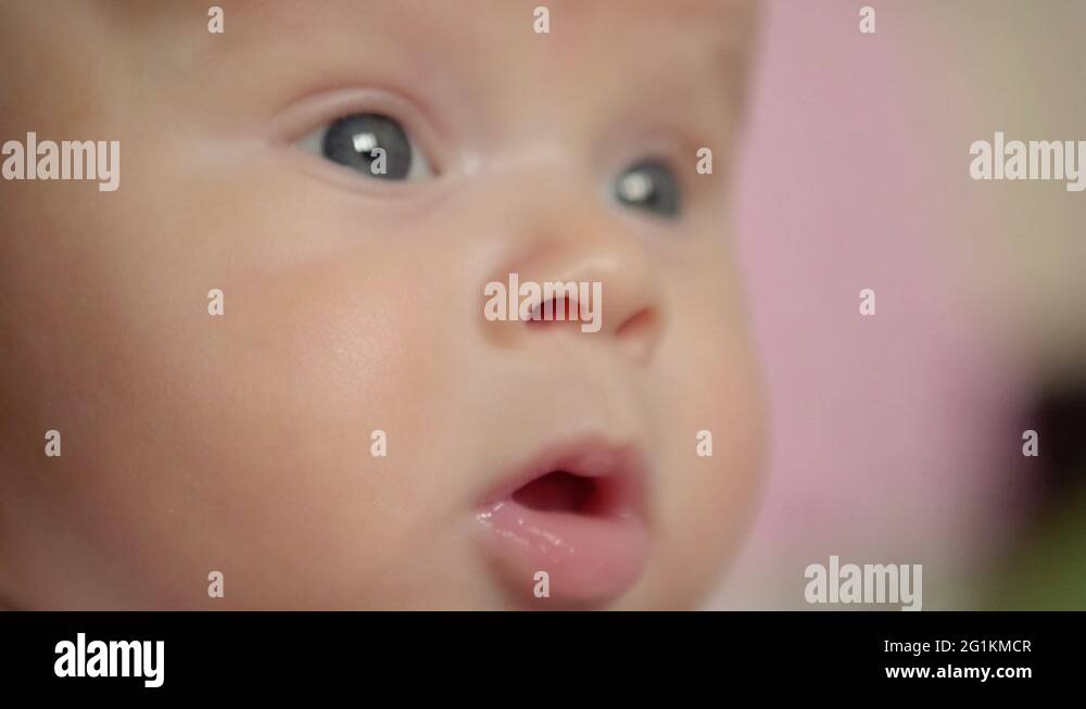 Cute baby's surprised face close up. Notice the reflections in the eyes ...