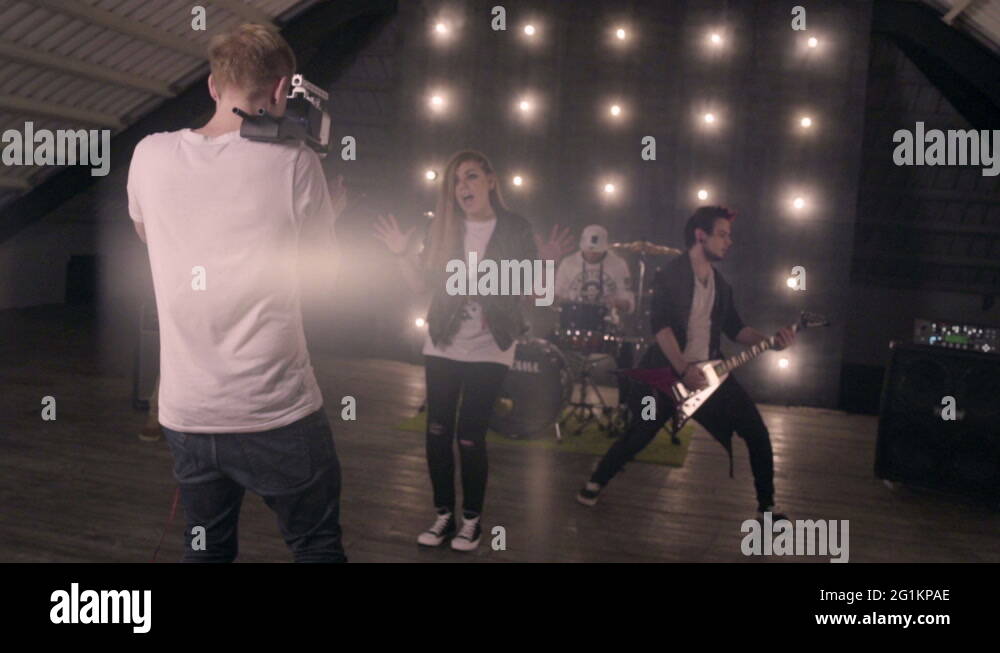 Behind the scenes. An operator film a scene of musical video with rock ...