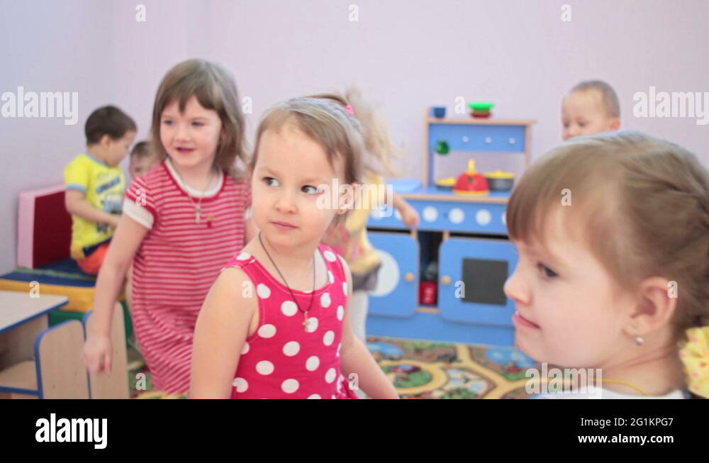 Kids playing running around dancing in kindergarten and laughter Stock ...