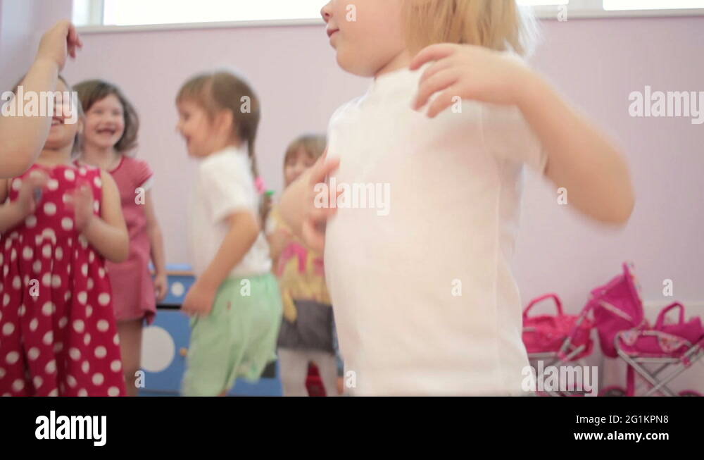 Kids playing running around dancing in kindergarten and laughter Stock ...