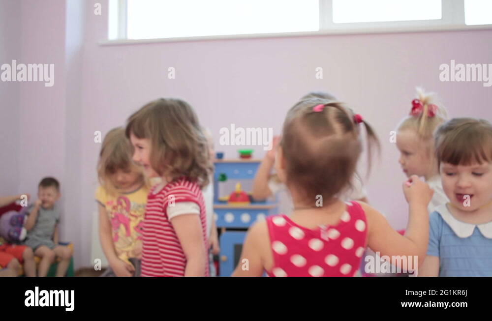 Kids playing running around dancing in kindergarten and laughter Stock ...