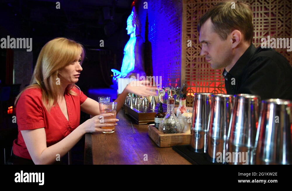 sad girl crying at the bar. drinks cocktails, night time. girl ...