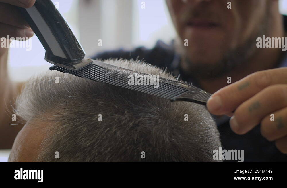 gray-haired man in a barber shop. Hairstyle is almost ready, Barber ...