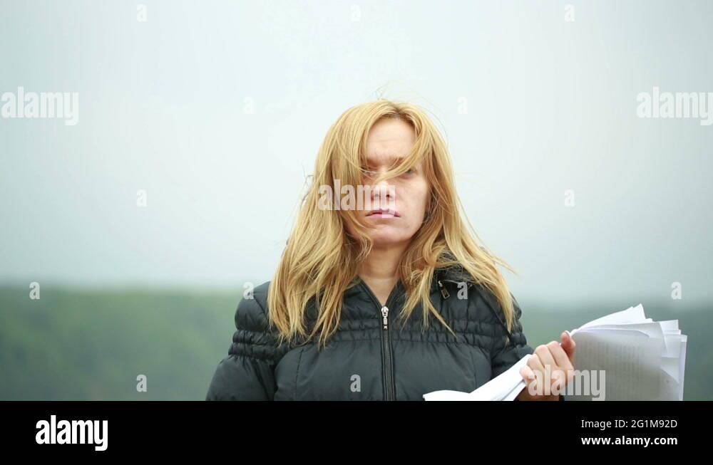 women on strong wind.bad weather Stock Video Footage - Alamy