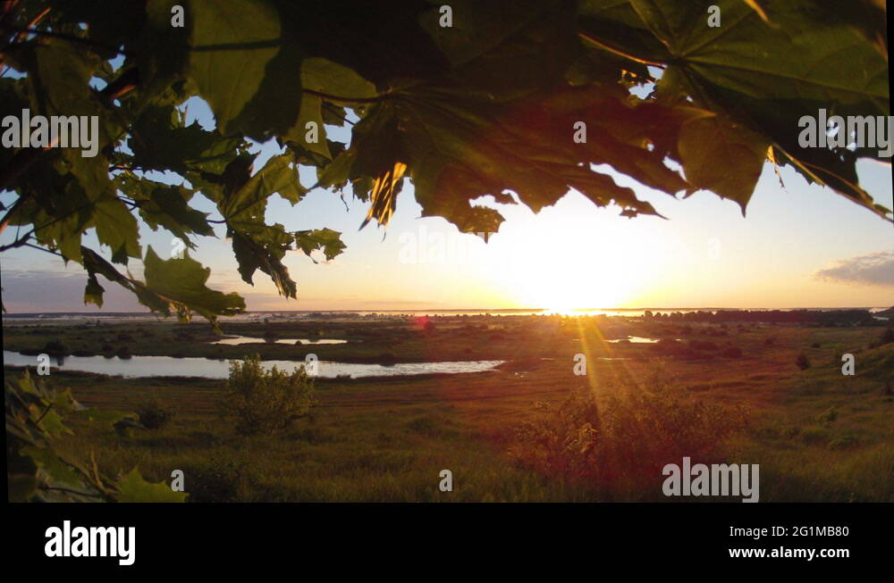 morning sunrise reflection in misty fog rise from flowing river water ...