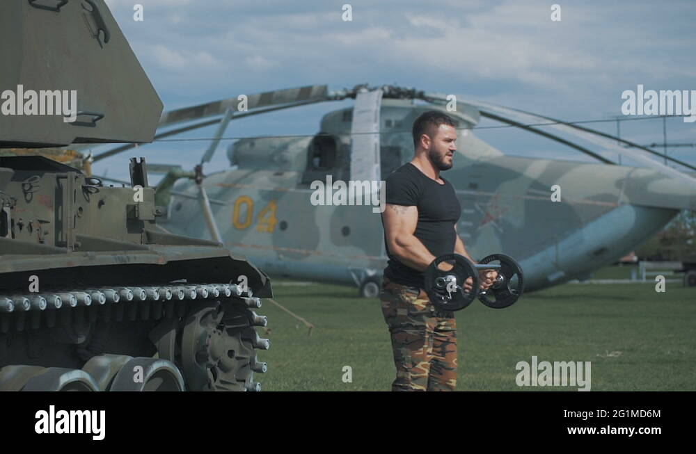 Muscular man in a military uniform has arranged training at a military ...