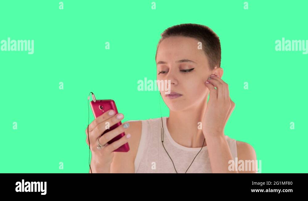 Beautiful bald girl, with short hair brunette on the green screen ...