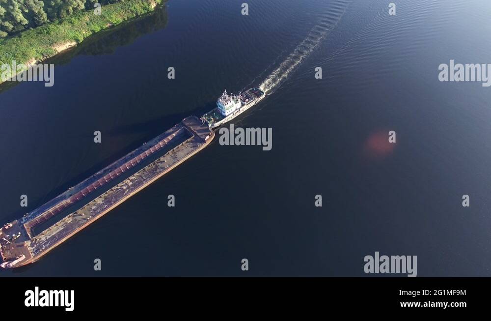 A tugboat and barge floating in the river. Aerial view Stock Video ...