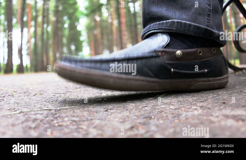 Black patent leather men's shoes stomping or fills rhythm on open air ...