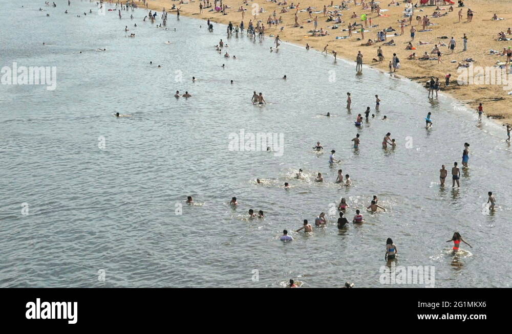 People sunbathing on the crowded sand beach Stock Video Footage - Alamy