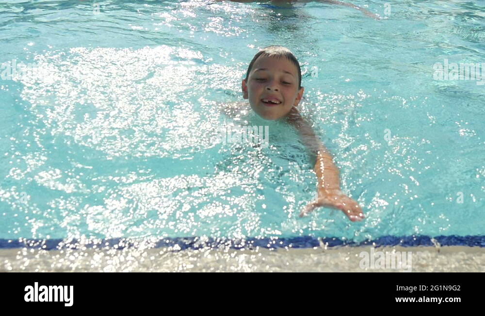 cheerful boy swimming in the pool , slow motion Stock Video Footage - Alamy