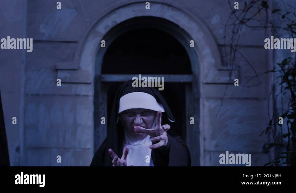 zombie nun. devilish woman in nun costume walking around the temple ...