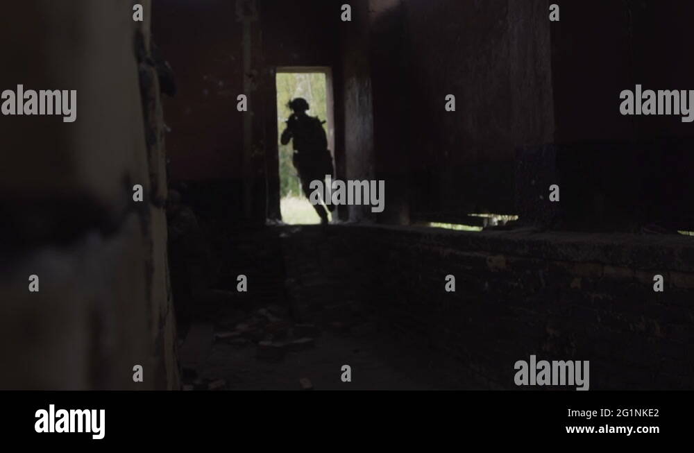 Two military pass through the door of the building the stairs. The ...