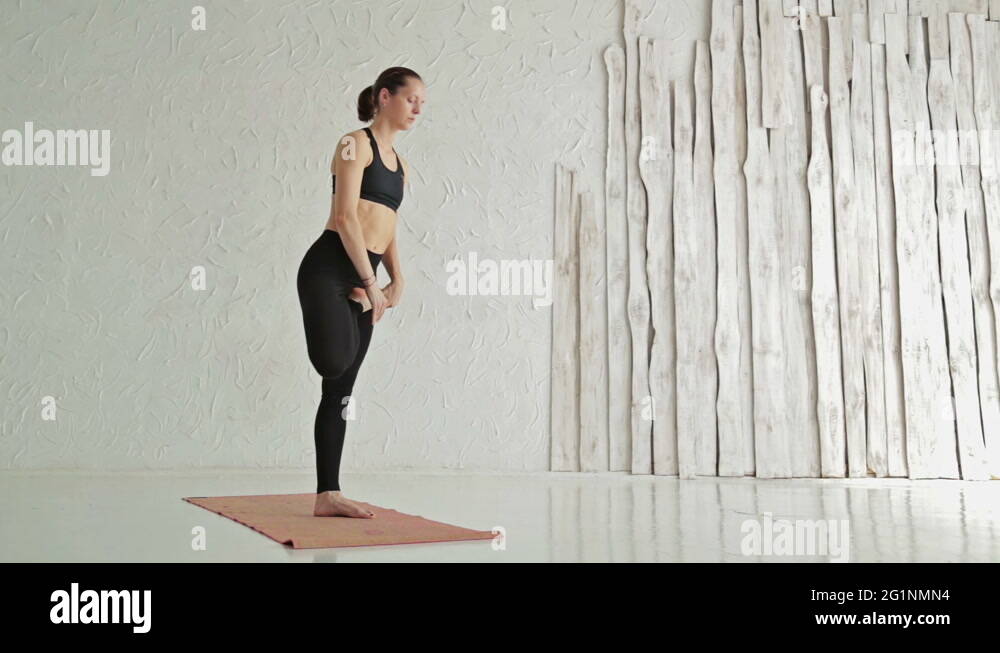 Woman practicing yoga - ardha baddha padma padangusthasana - balancing ...