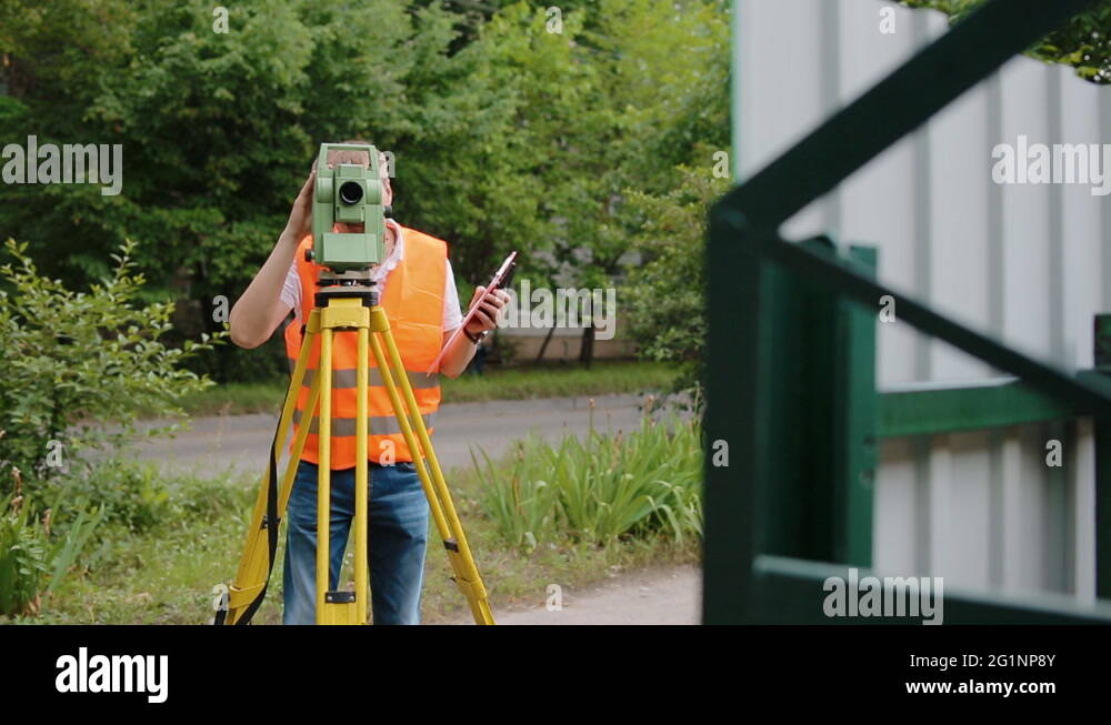 Surveyor at work measuring the distance Stock Video Footage - Alamy