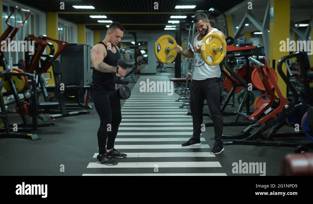 Two men at the gym doing exercises Stock Video Footage - Alamy