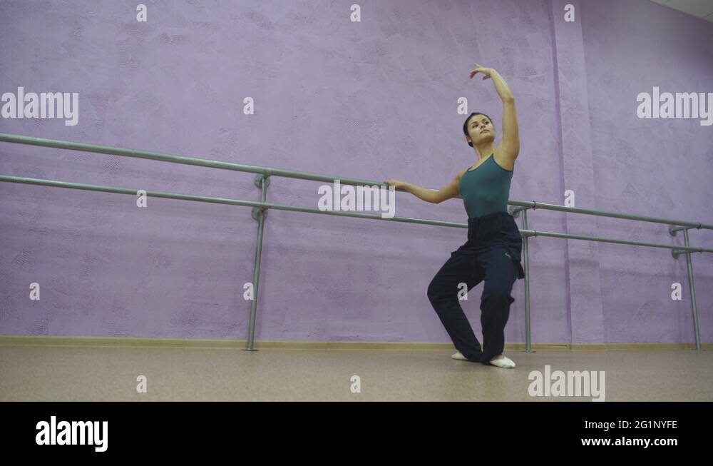Young caucasian ballerina girl showing various ballet steps and ...