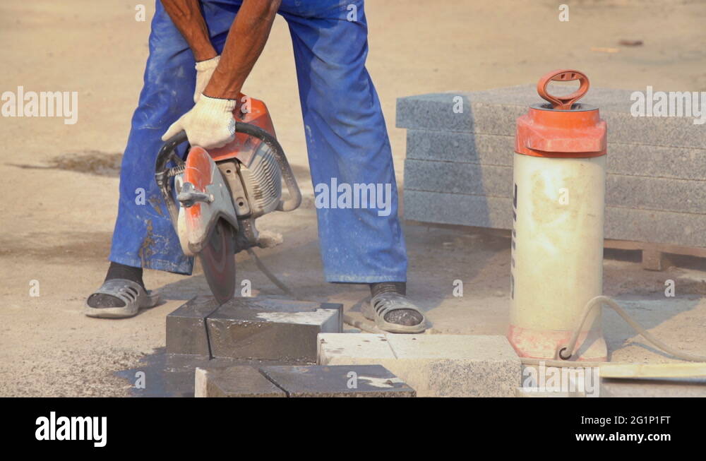 Construction Worker Cutting Concrete Block With Circular Saw Stock ...