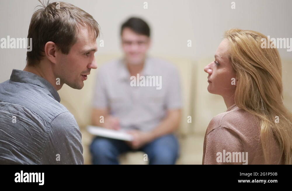 male psychologist helping worried young couple. family therapy. angry ...