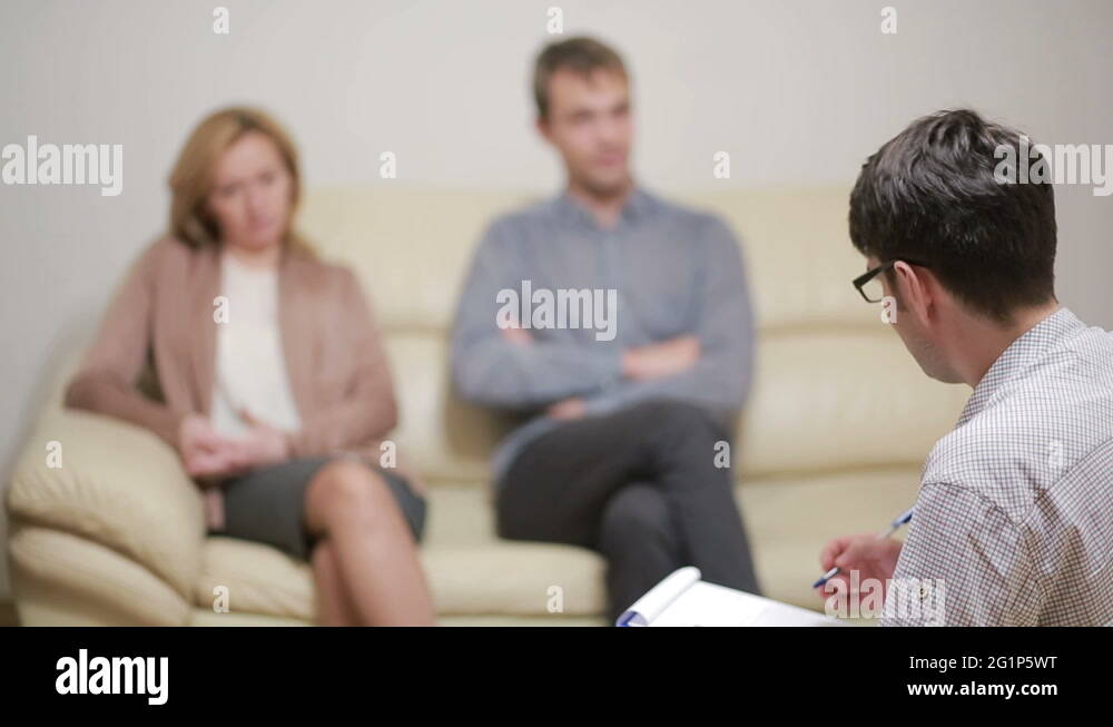 male psychologist helping worried young couple. family therapy. angry ...