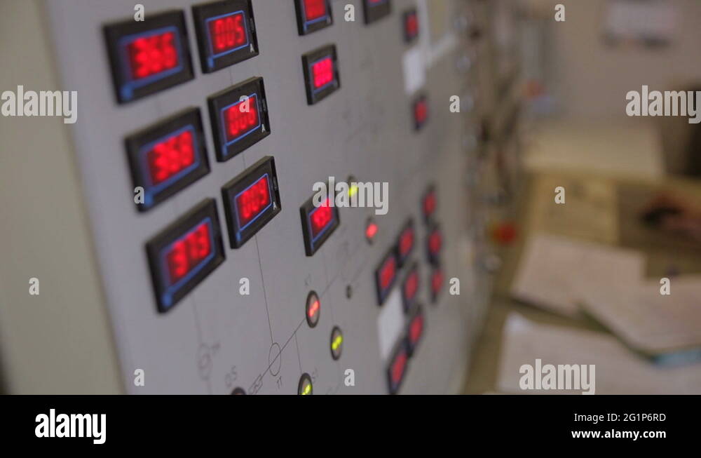 Industrial worker operating control paanel in control room of a ...