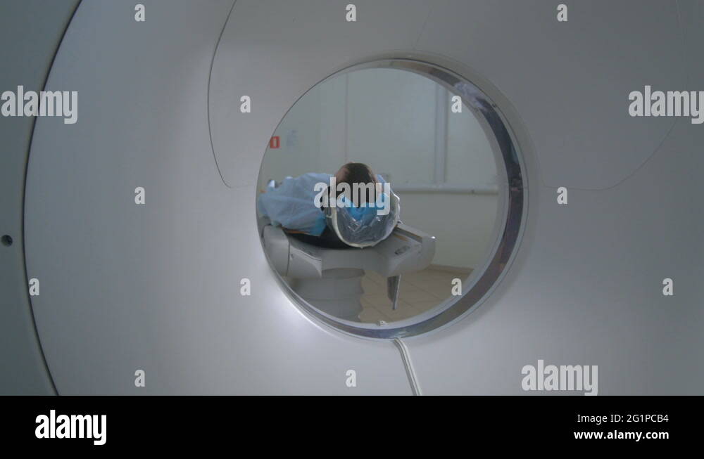 Patient in a Emergency hospital MRI scanner. Man lays in Magnetic ...