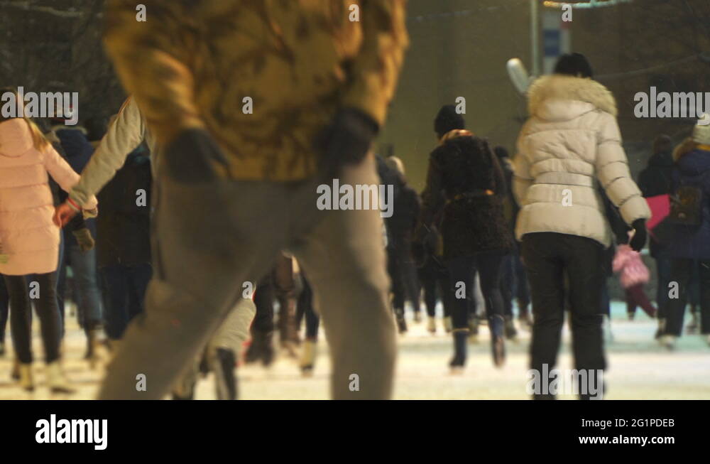 Concept Friendship and Love. Crowd at Night City Skating Rink. Falling ...