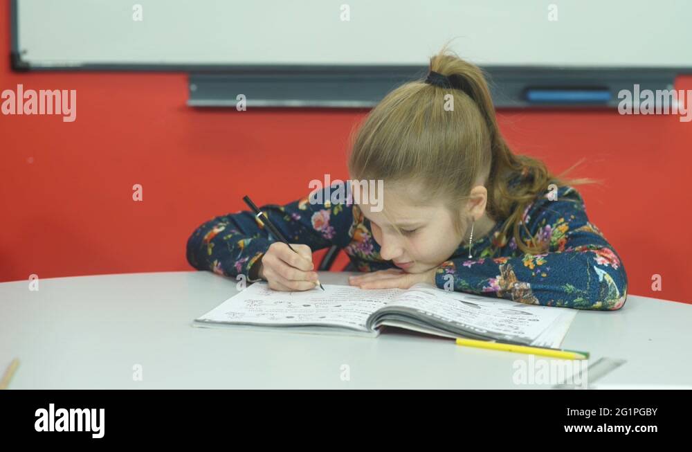 Boring sad expression student schoolgirl on classroom desk at school ...