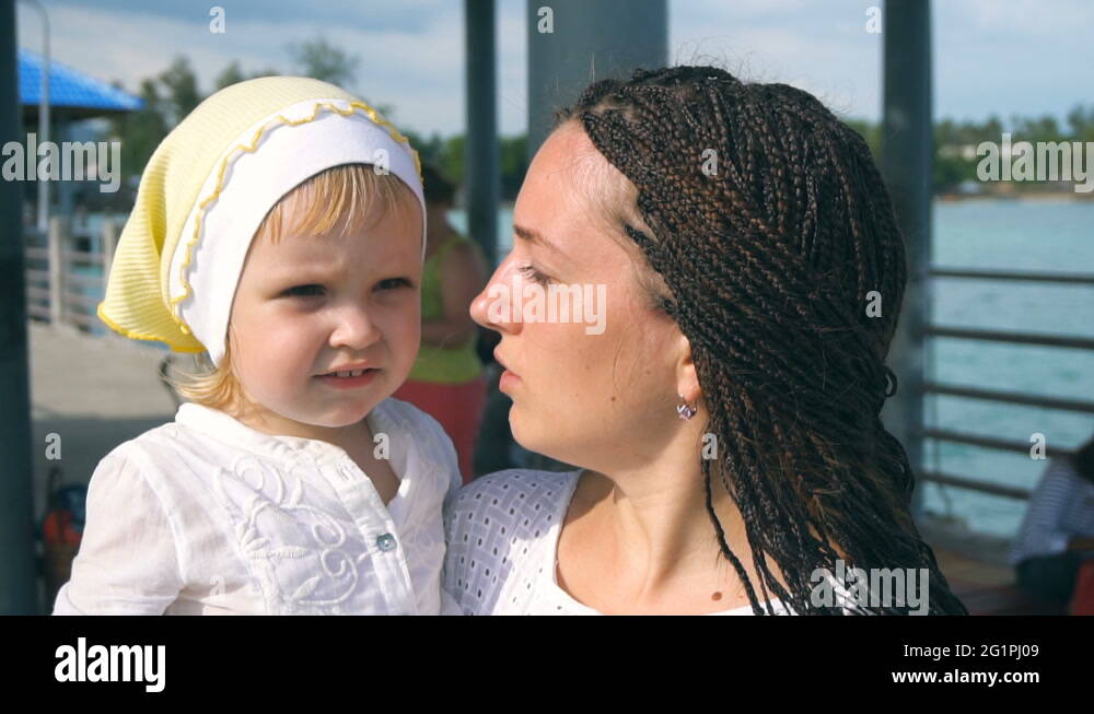 Mother with african braids looking afar with little daughter Stock ...