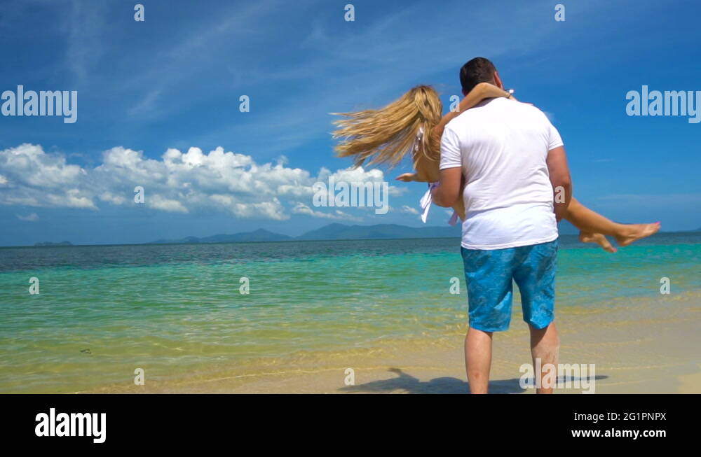 Romantic Couple Spinning and Embracing in Water, Laughing and Splashing ...