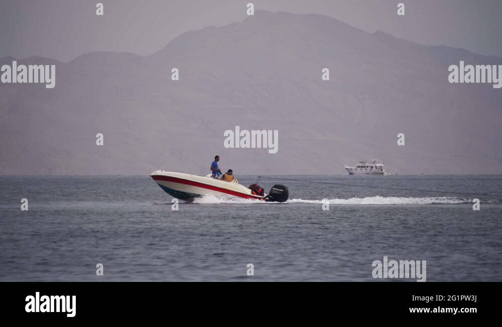 Water Extreme Bumper Tube Ride behind the Boat on Red Sea. Slow Motion ...