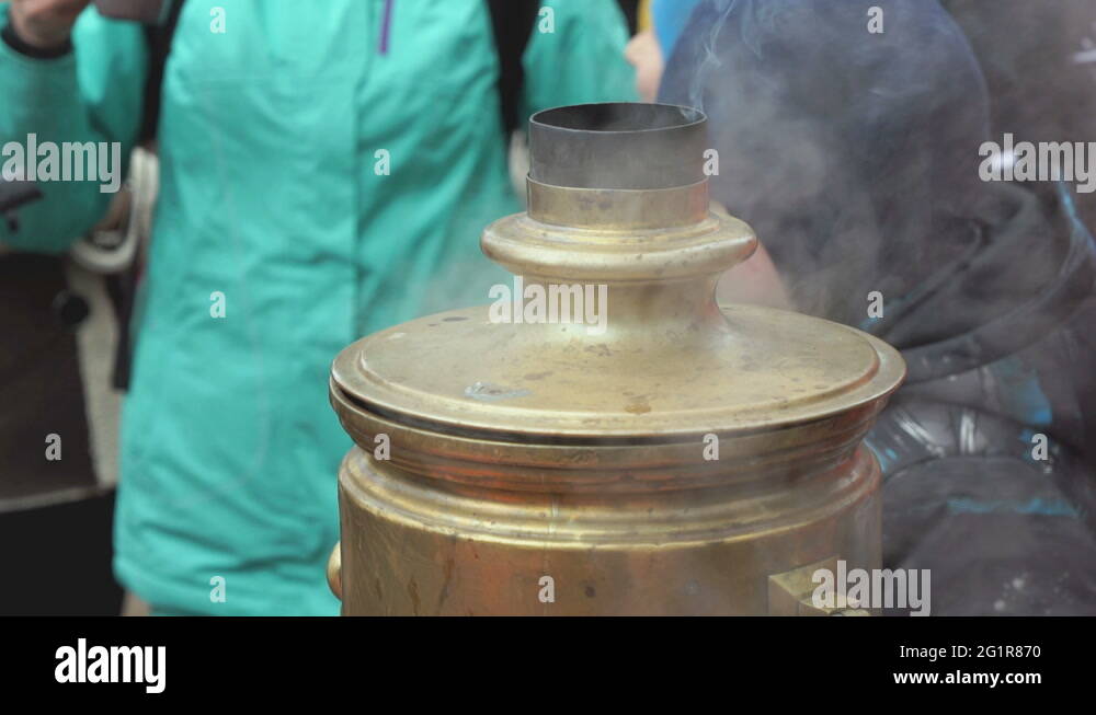 People standing around russian boiling samovar Stock Video Footage - Alamy