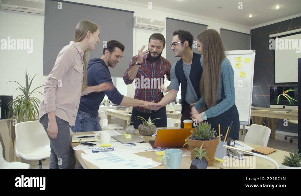 Team putting hands together and raising arms up Stock Video Footage - Alamy