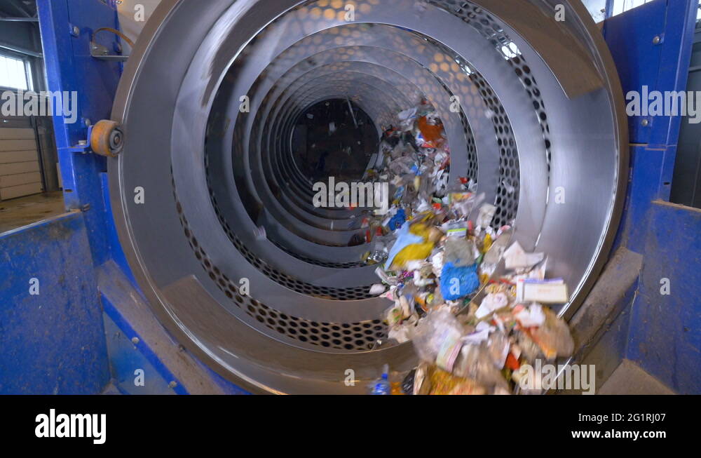 Trash in a waste sorting machine, barrel at a recycling plant. No ...