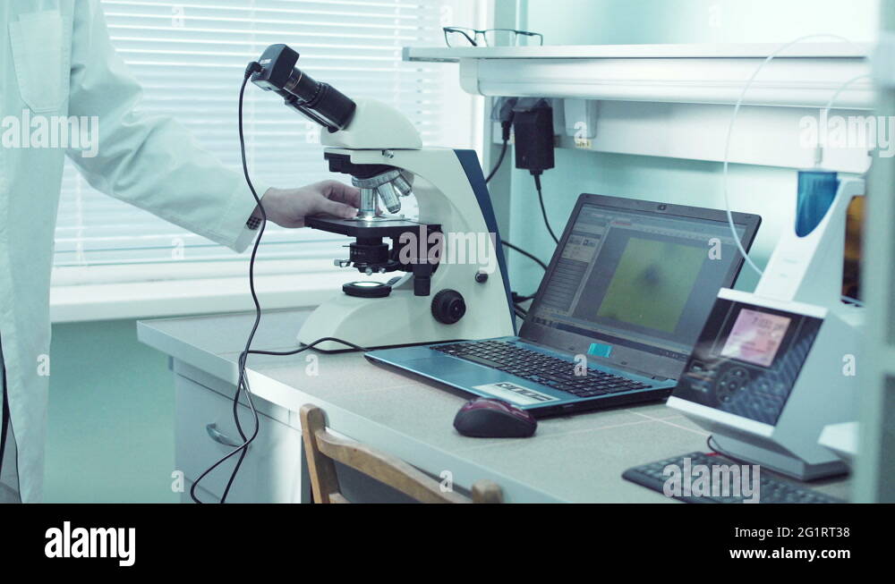 Tutor showing electron microscope Stock Video Footage - Alamy